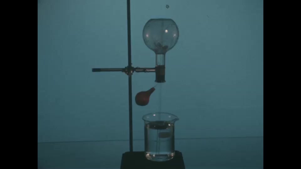 1960s: Liquid siphons from beaker into balloon flask through tubing ...