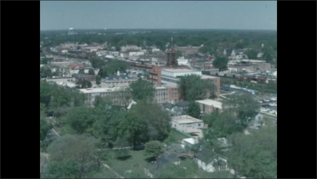 1950s: Suburbs, trees, lawns, houses, roads, buildings, parking lot ...