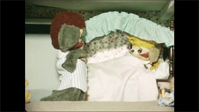 1970s: Girl mouse puppet hides under covers in bed. Father mouse puppet ...