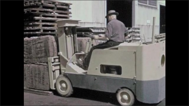1960s: People on loading docks. Forklift pulls up to pallet loaded with ...