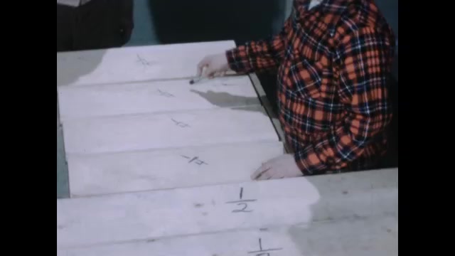 1940s: Boy pointing to writing on wooden boards. Boy with clapboard ...