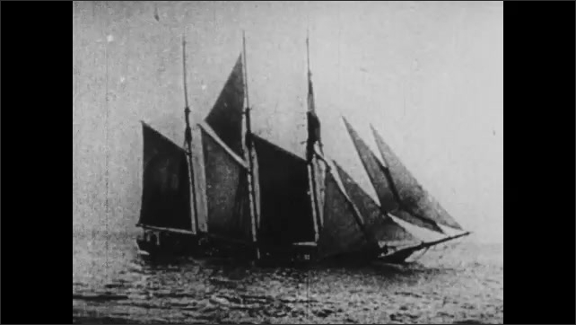 1910s: Ships burn and sink. Men row away in lifeboat. Men stand in crow ...