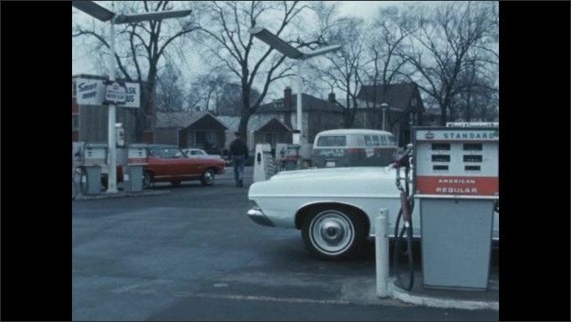 1960s: Service station, man holds microphone, interviews man wearing ...