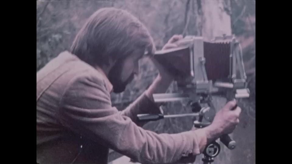 1970s: Photograph of man looking through camera. Collage of images ...