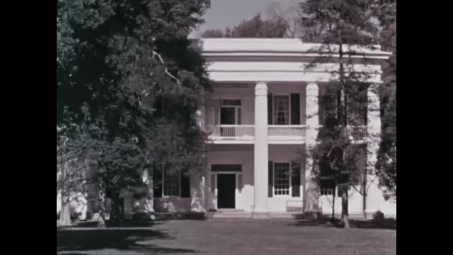 1970s: mansion facade with columns, cotton pickers with sacks in field ...