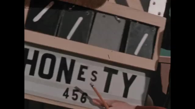 1950s: Hands hold up clapboard. Teenage boys sit in a restaurant booth ...