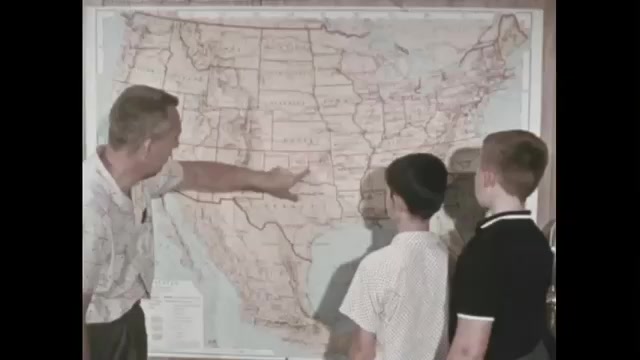 1960s: Man gestures at map of United States. Man gestures at map legend ...