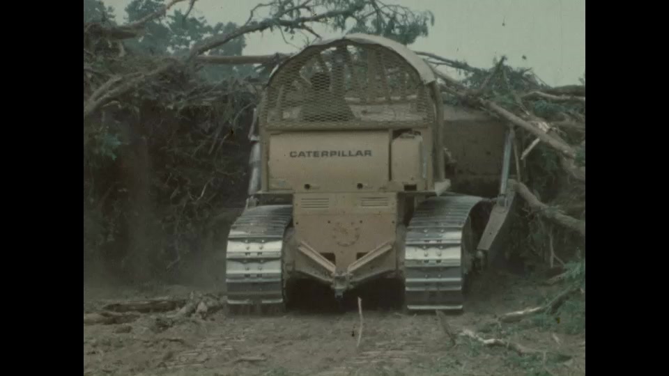 1960s: Bulldozer pushes dirt and fallen trees on construction site ...