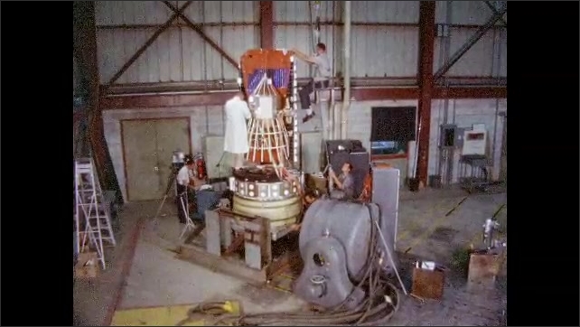 1960s: Scientists and engineers work on prototype satellite in ...