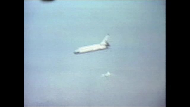 1980s: UNITED STATES: side profile of space shuttle in sky. Space ...