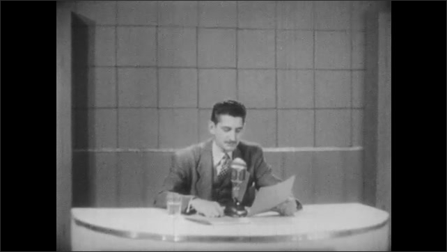 1940s: Man plays record on record player. Man sits behind table ...
