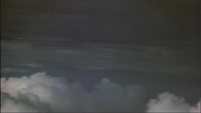 1940s Bikini Atoll: clouds in sky, seen from plane. Atomic bomb ...