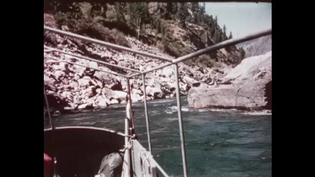 1950s: boat navigates past rocks and boulders throughout the river ...