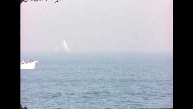 1960s: Ocean with sailboat on horizon. Speed boat goes by. – Archival ...