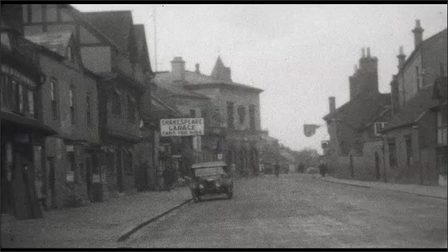 1930s: Cottage. Buildings along street in town. Castle. – Archival Footage