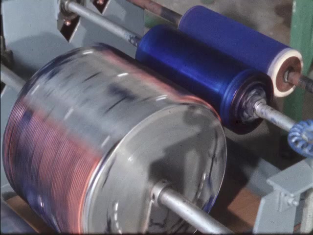 1950s: Rollers of blue dye spin in machine. – Archival Footage