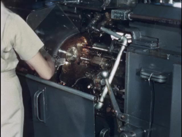 1950s: Woman stands at industrial lathe, turning bullet shell casings ...