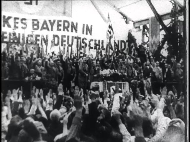 1950s: Adolph Hitler speaking to crowd. Tanks driving over hill. Tank ...