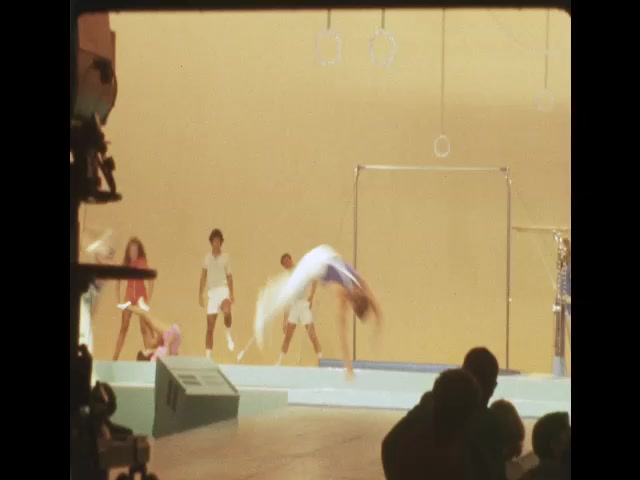 1970s: Men and women sing and perform gymnastics and exercise on stage ...