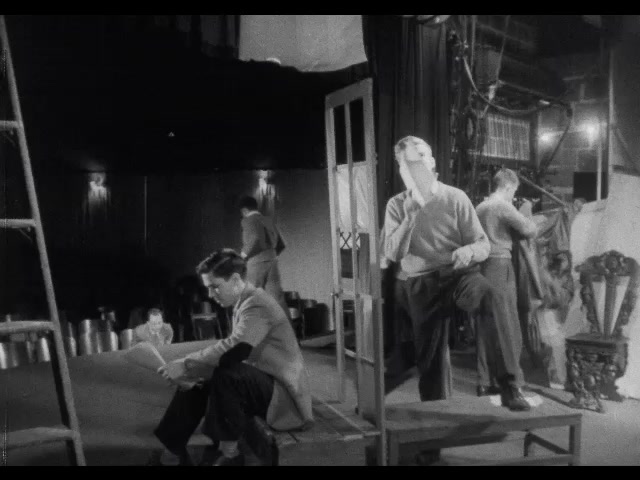 1950s: Man directs stage setup. – Archival Footage