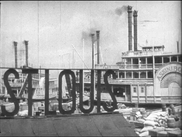 1920s: Sign reads “ST. LOUIS.” Dock. Steamboat. Men carry loads to ...