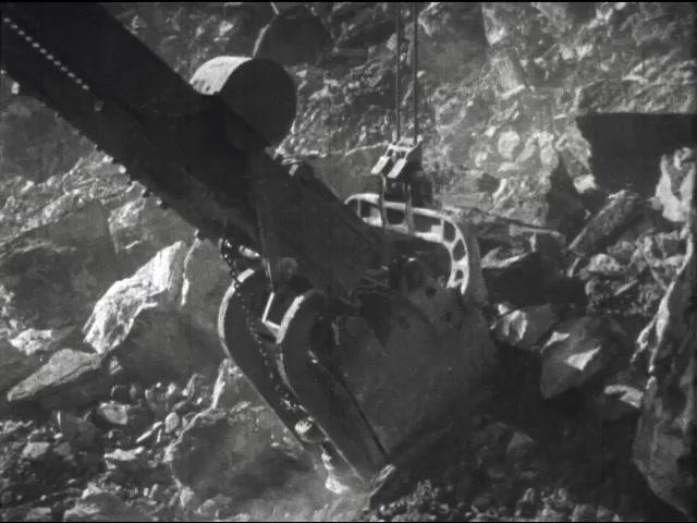 1920s: Construction site. Excavator. Man uses jackhammer. Men work on ...