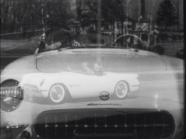 1950s: Tracking shot, man and woman driving in car. – Archival Footage