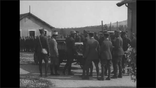 1910s: Soldiers place coffin in back of military truck as soldiers ...