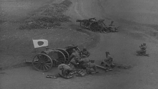 1940s China: Soldiers fire weapons at each from across field. Soldiers ...
