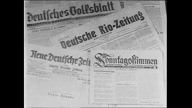 1940s: Newspapers. Glider exiting hang, man climbing in Storefront ...