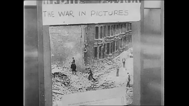 1940s: Photo of rubble in city. Battleship. Sailor looking through ...