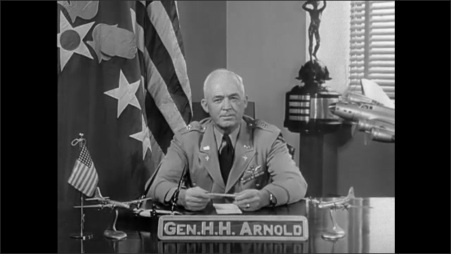 1940s: General H.H. Arnold talks sitting behind desk with flags and ...