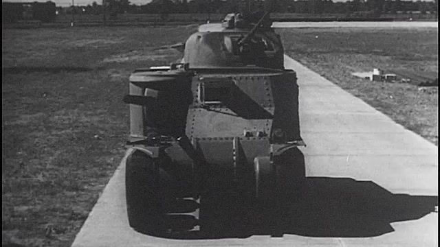 1940s: Tanks drive on tracks. Bridge. Water tower. – Archival Footage