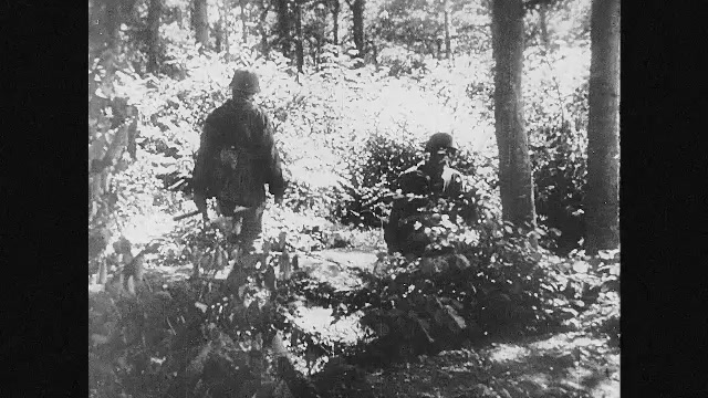 1940s: Soldiers walking through forest. Soldiers move through forest ...