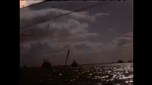 1940s: Ships in silhouette. Soldiers grabbing large shells. Rocket ...