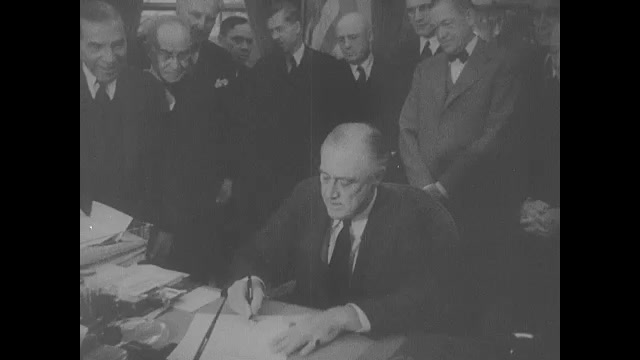 1940s: President signs paper. Nazi rally. Hitler gives speech ...