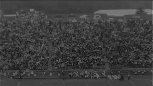 1960s: Fans at stadium. Football game. – Archival Footage