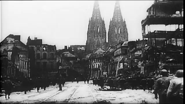 Germany 1940s: People walking through a bombed out town. People walk ...