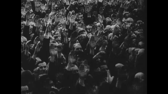1930s Germany: Civilians cheer as Nazi soldiers march through city ...