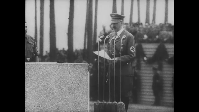 1930s: Adolf Hitler gives speech from podium at Nuremberg stadium ...