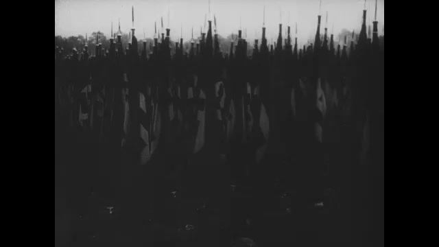 1930s: German soldiers march with Nazi flags at rally at Nuremberg ...