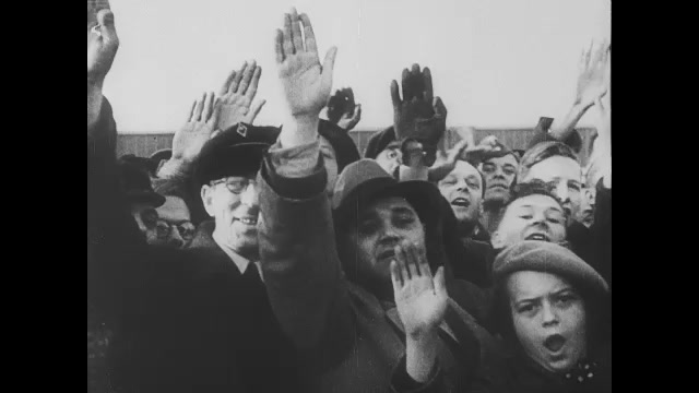 1930s: People in crowd giving Nazi salute. Hitler drives by crowd in ...