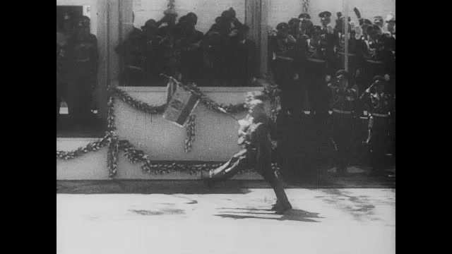 1930s Germany: Nazis march. Leaders stand. Nazi parade. Hitler gives ...