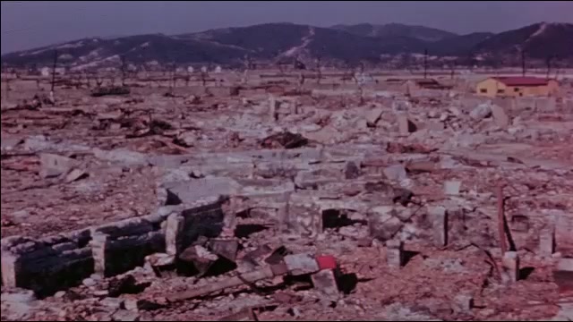 1940s: Land covered with debris and half standing buildings from bomb ...