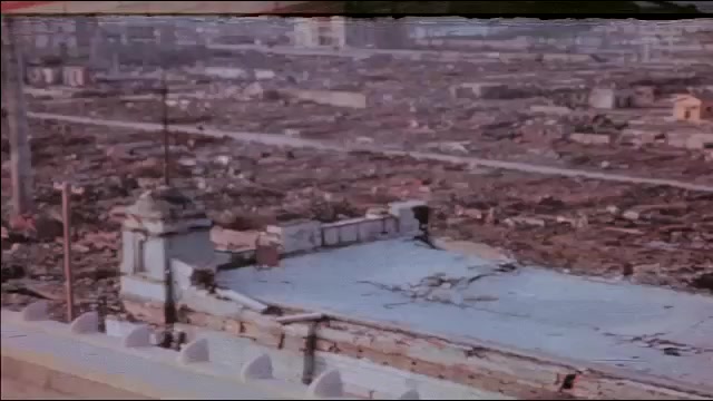 1940s: Looking over roof of destroyed building at rubble strewn across ...