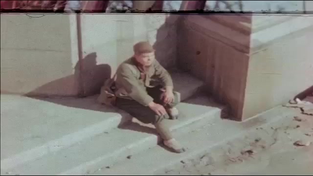 1940s: Japanese soldier sits on steps of building in bombed out ...
