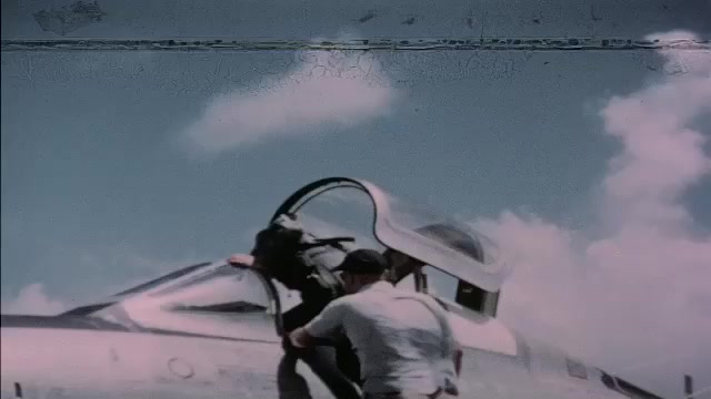 1950s: Pilot climbs into cockpit of jet plane. Fighter pilot in cockpit ...