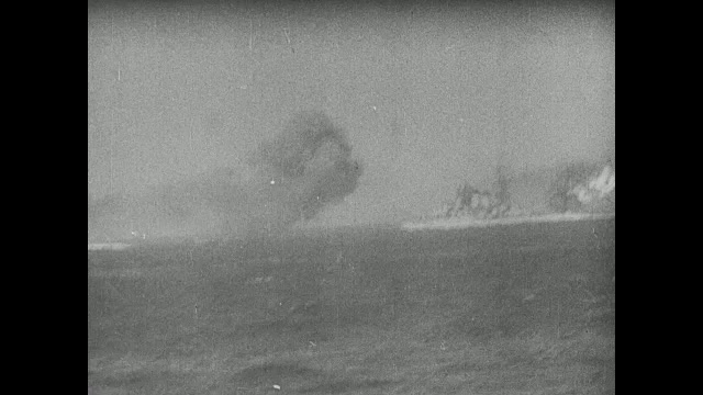 1940s: Explosion in water. Wreckage of ship. Ship breaks apart and sinks. Men pile into ...