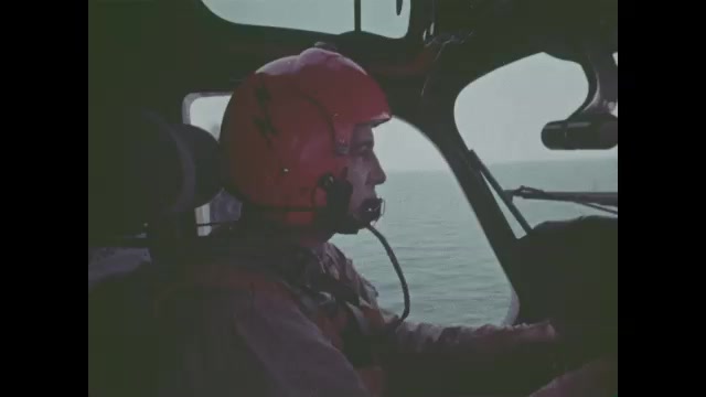 1960s: Pilot flies airplane. Cockpit. Men receive data in control room ...
