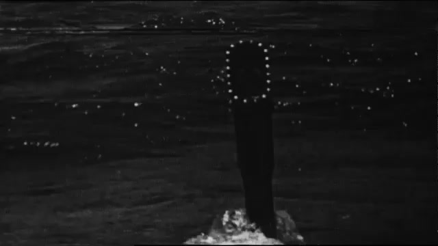 1940s: Submarine periscope sticks out of water. Ship. Men in control ...